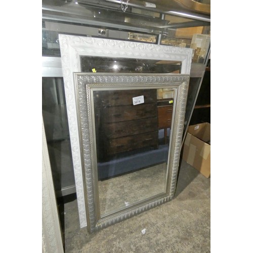 Two large rectangular wall mirrors in decorative frames