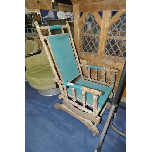 An Edwardian turned mahogany American style rocking chair