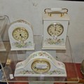 Three floral decorated porcelain cased Aynsley mantle clocks
