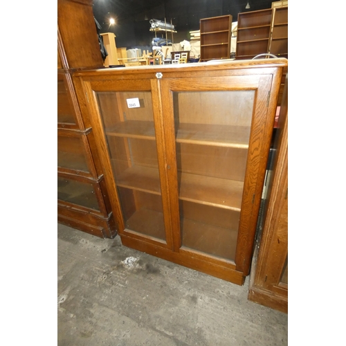A vintage golden oak floor standing display cabinet with two glazed ...