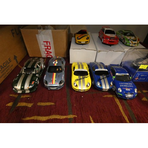 A Scalextric racing set with cars, track and controllers (two shelves)
