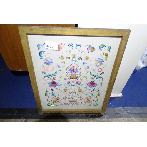 An oak framed embroidered fire screen