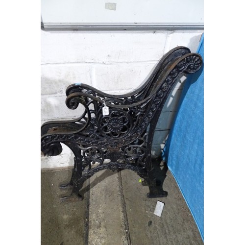 A pair of very ornate cast iron bench ends
