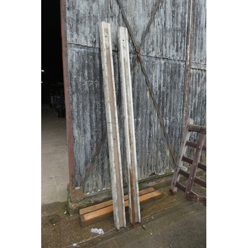 2 x concrete gate posts, each measuring approx 9cm x 10cm x 244cm