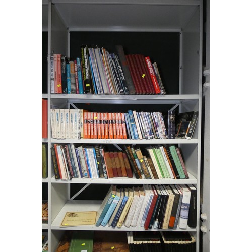 A quantity of hardbacked and paperback books (4 shelves)