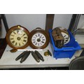 Two vintage wooden case wall clocks and other clock parts (one shelf)