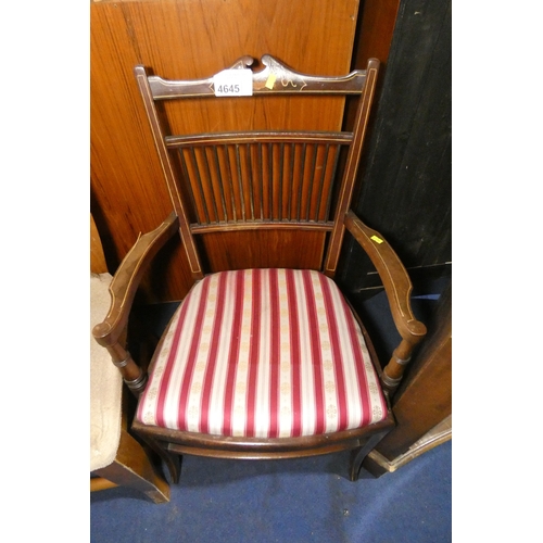 An Edwardian inlaid mahogany elbow chair with a spindle back and a red ...