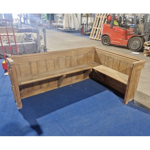 An early 20th century vintage pine corner ecclesiastical pew