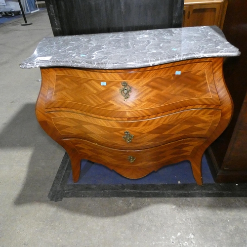 A reproduction French style bombe front chest of three drawers with a ...