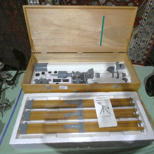 A vintage Hilkin astronomical telescope with wooden tripod and carrying box
