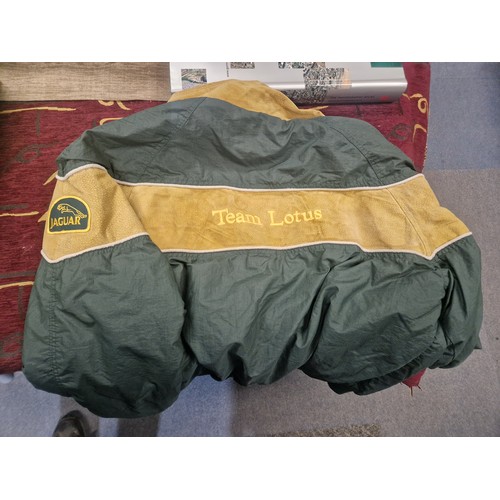 A vintage black leather jacket and a vintage Team Lotus jacket (one shelf)
