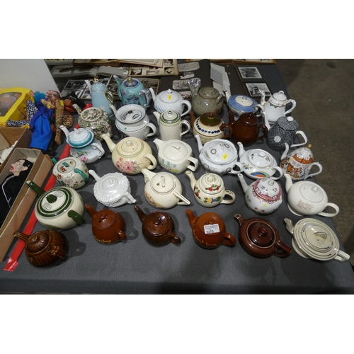 A collection of small decorative vintage teapots