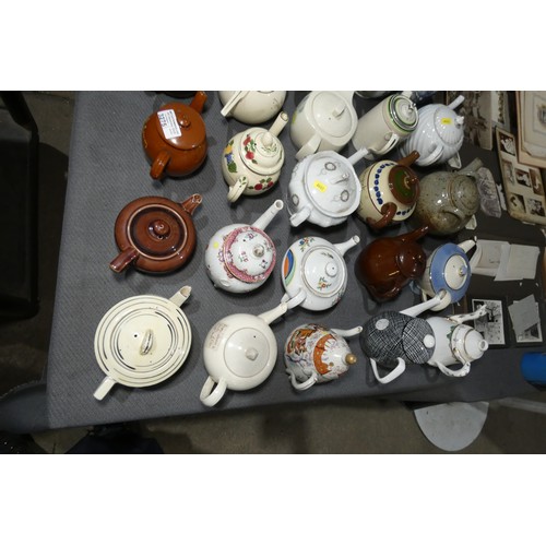 A collection of small decorative vintage teapots