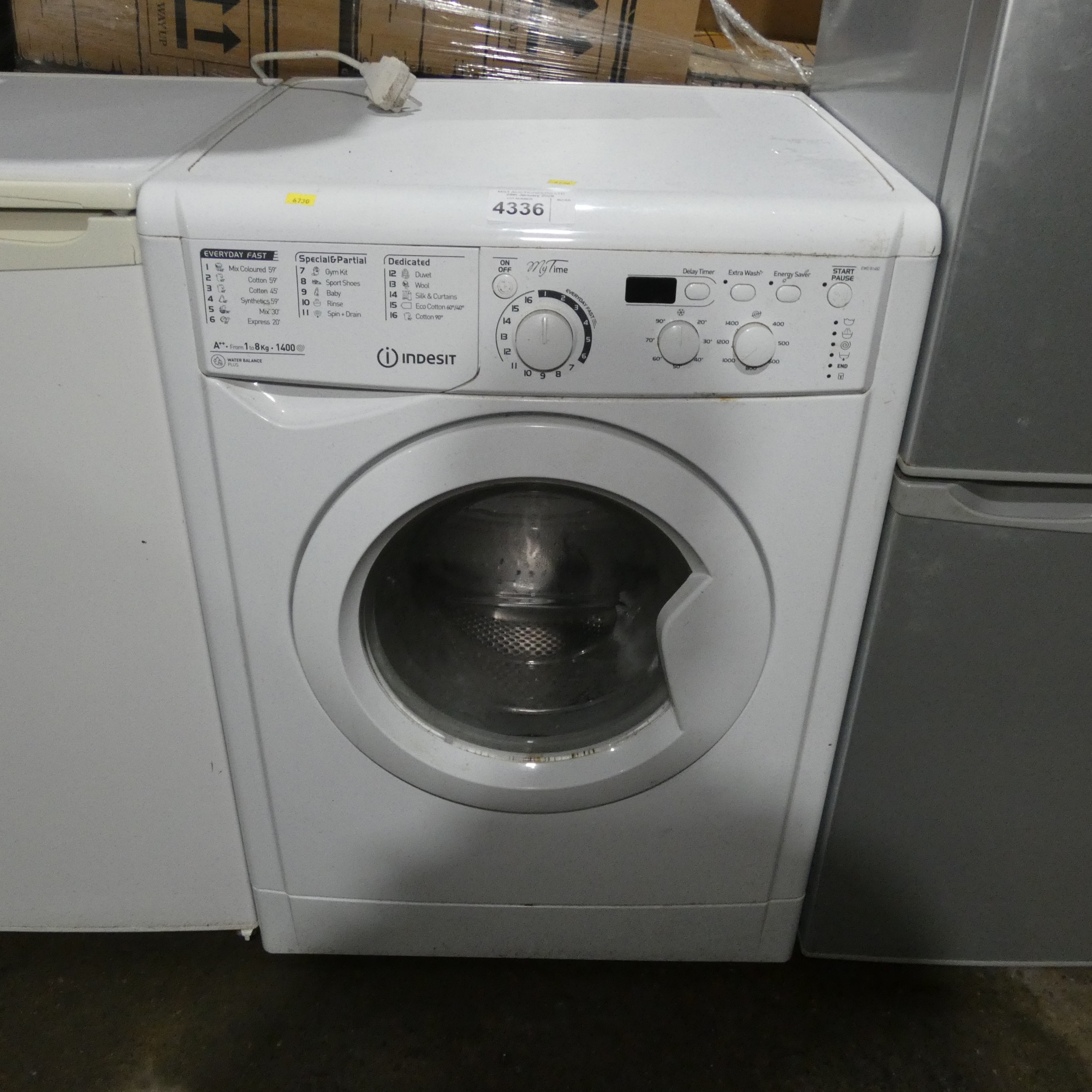 A white under counter washing machine by Indesit 8kg Trade