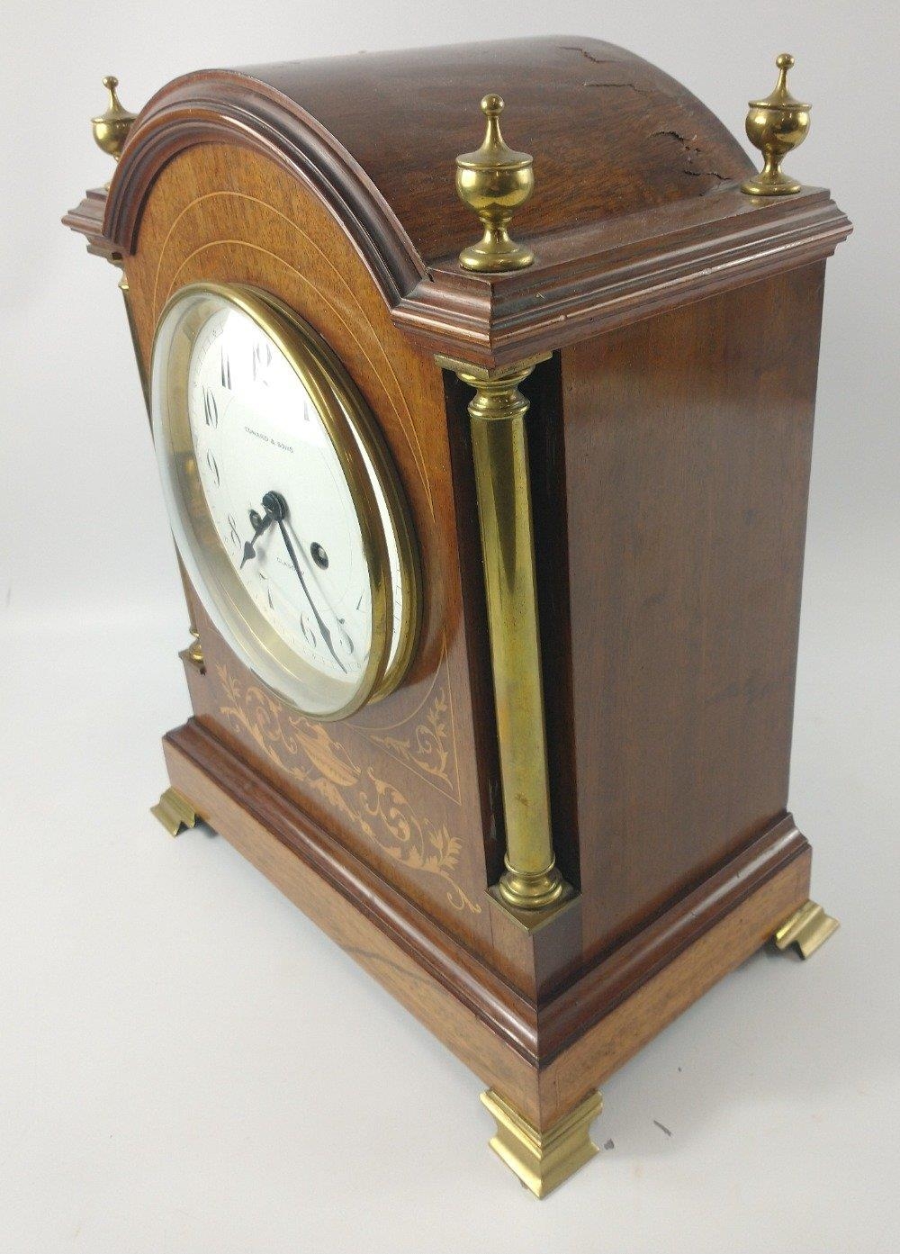 A Sheraton-style bracket clock with marquetry inlay with bracket ogee ...