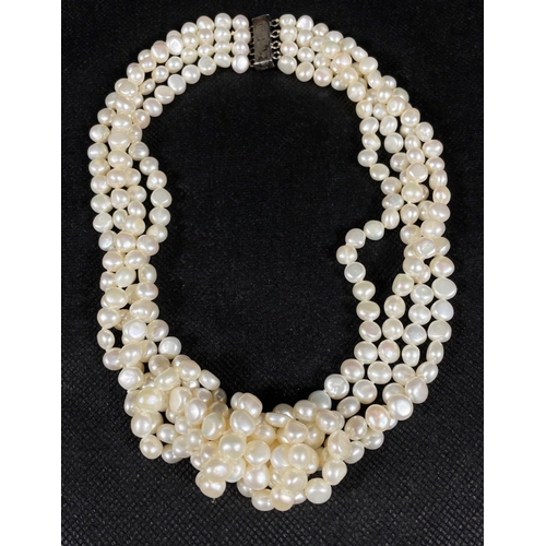 A four-string PEARL NECKLACE with 925 marked silver fastener, pearls ...