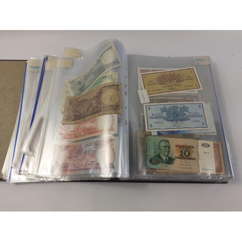 A substantial album containing world banknotes. Well over 300 notes in ...