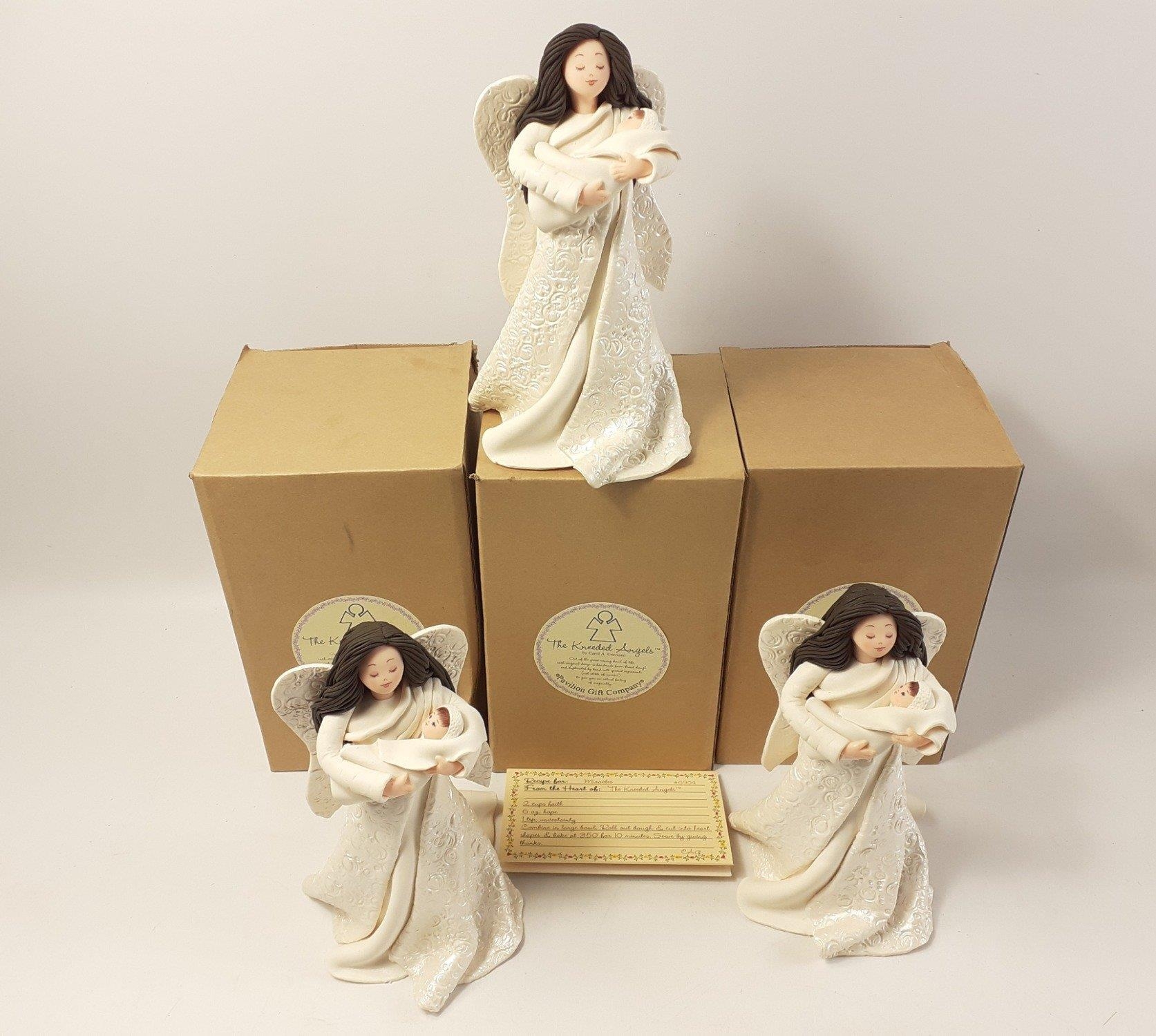 Three KNEEDED ANGELS figurines in boxes. Each standing approx 21cm tall ...