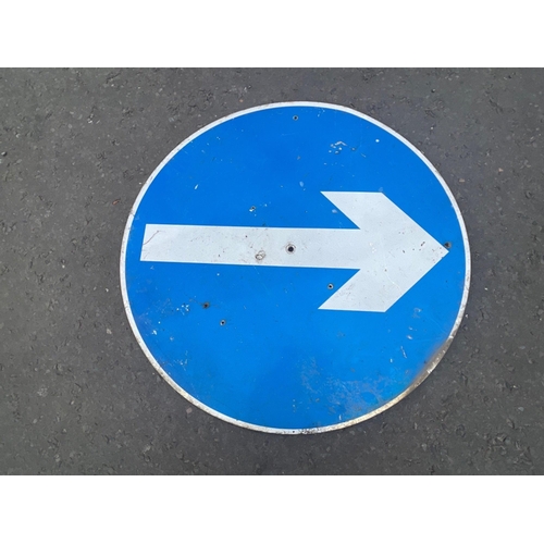A metal CIRCULAR aluminium directional white arrow on blue background ...
