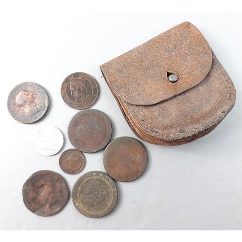 An antique leather coin purse containing a selection of copper coinage ...