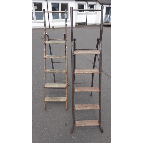 Two metal tube frame folding ladders with 5 wooden steps#489