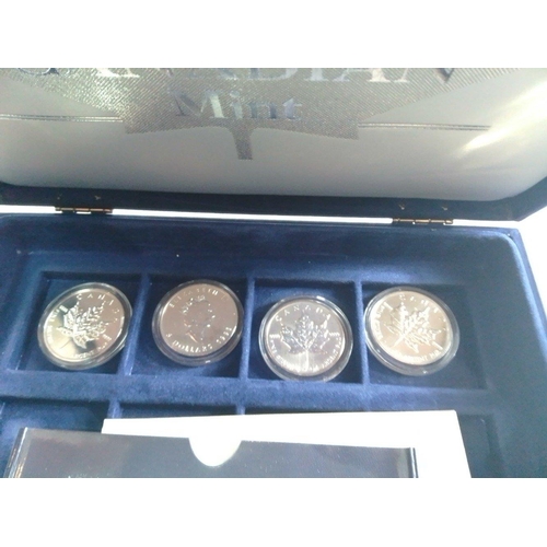 A Canadian Mint case with four Silver Maple Leaf coins. Encapsulated ...