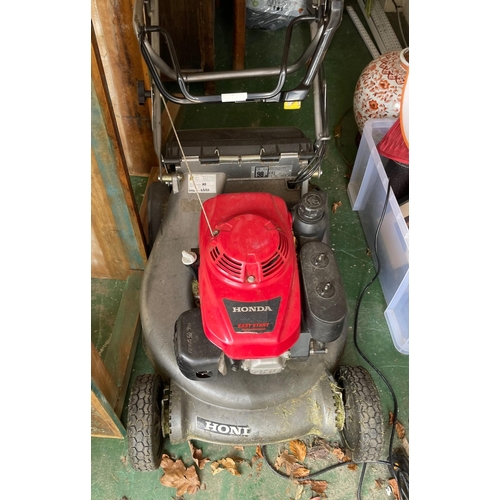 A petrol HONDA EASY START lawnmower with an in-built heavy grass roller ...