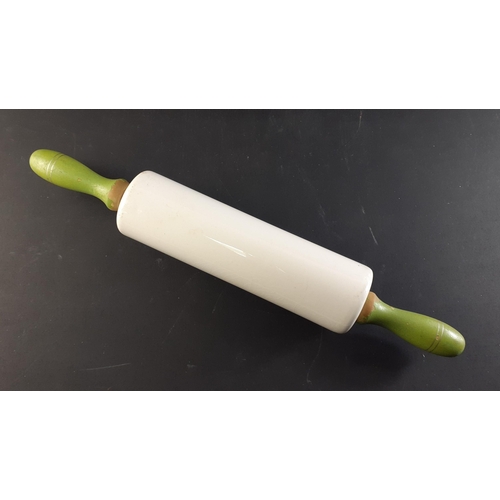 A vintage ceramic rolling pin with wooden handles. Approx 44cm with ...