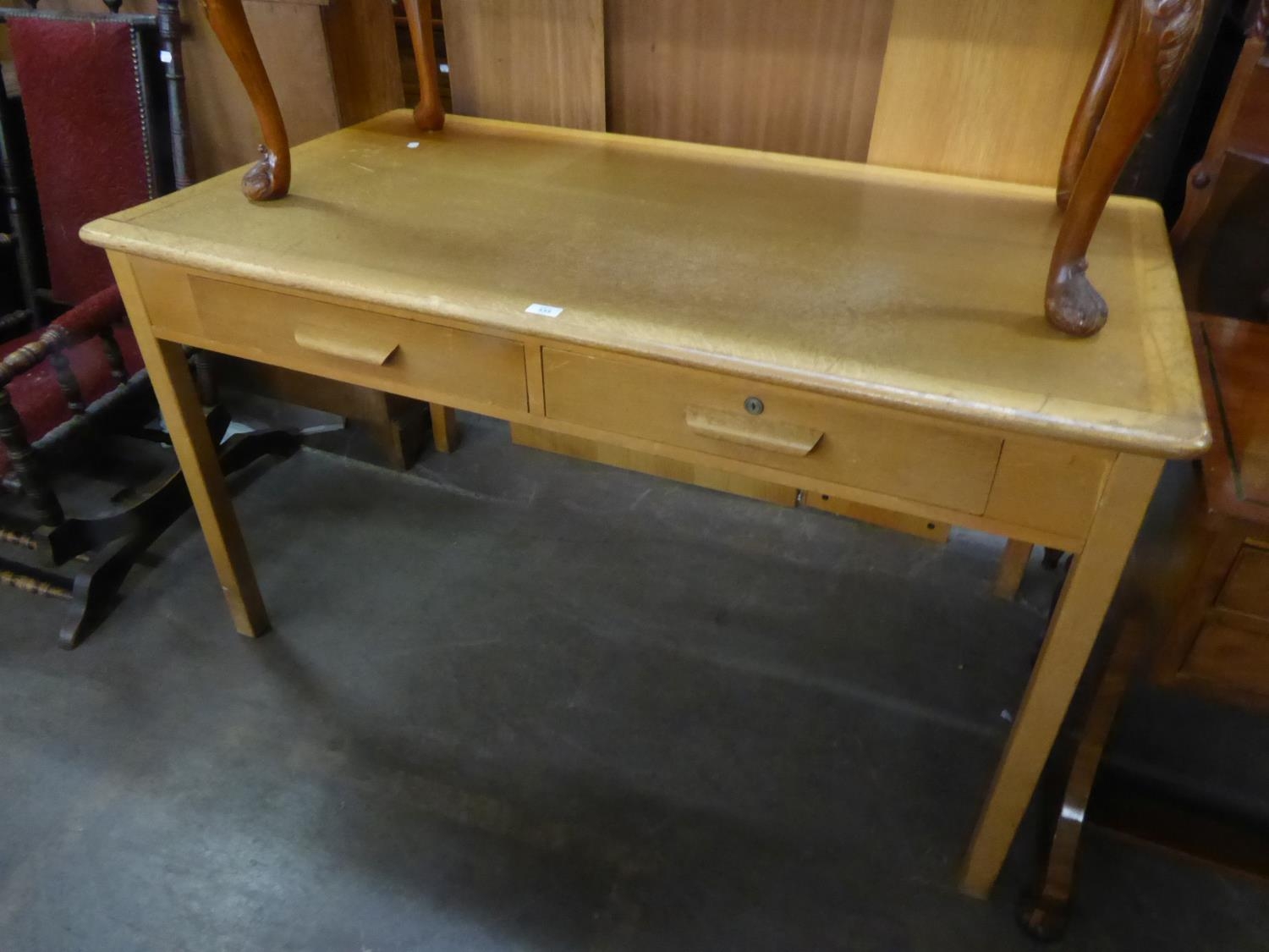 A LIGHT OAK DESK WITH PANEL END SUPPORTS AND A LIGHT OAK OFFICE WRITING ...