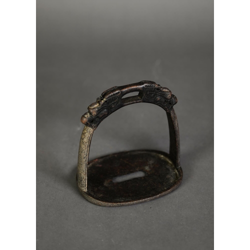 AGED ORIENTAL CAST METAL STIRRUP, cast with stylised dragon mask and ...