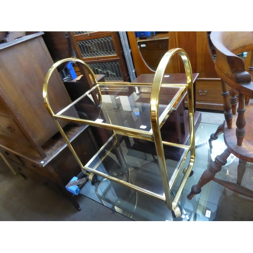 STYLISH GILT METAL FRAMED TWO TIER TEA TROLLEY, WITH TWO SMOKED GLASS ...