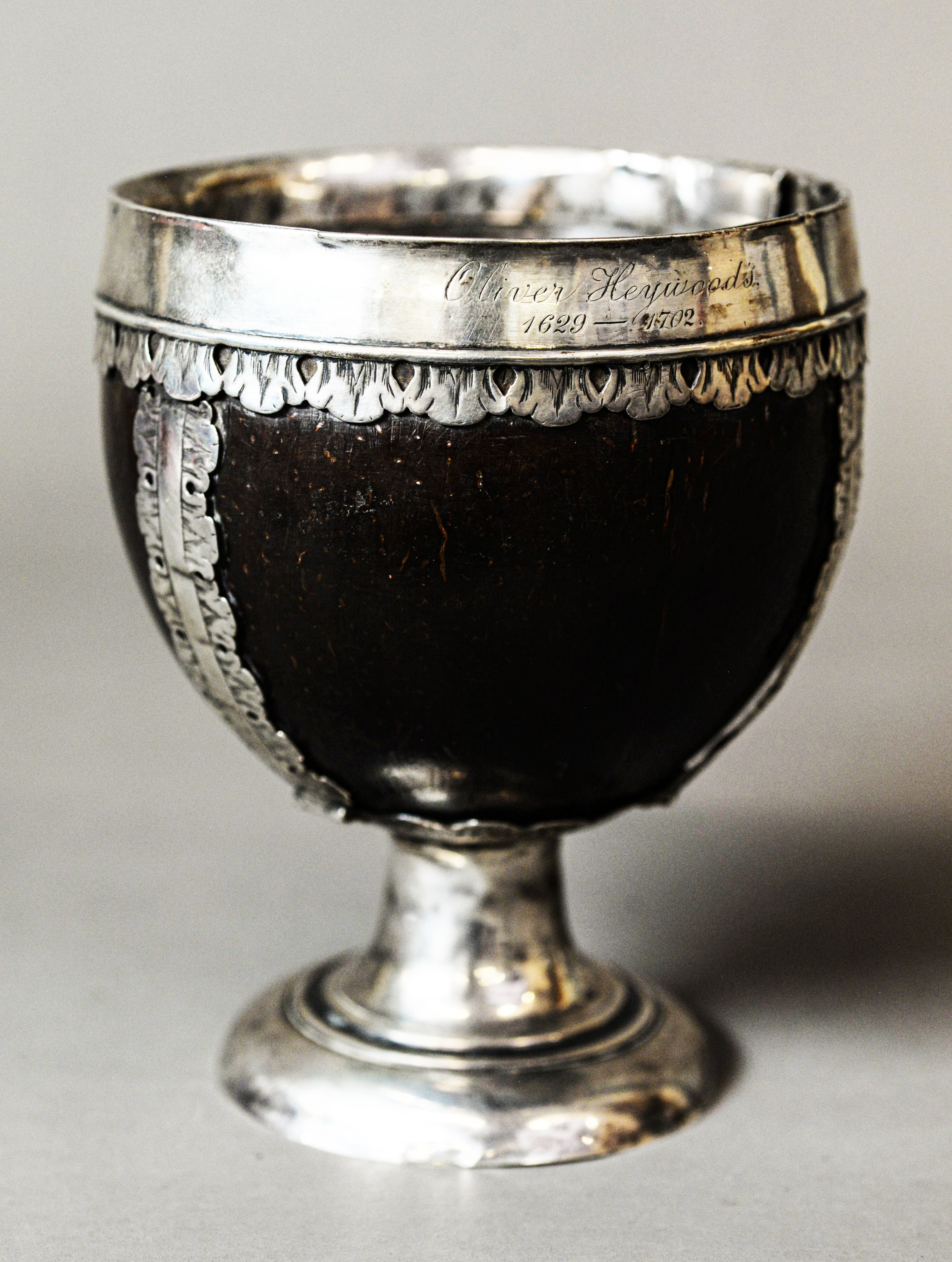 AN 18TH CENTURY SILVER MOUNTED COCONUT CHALICE, probably used for holy ...