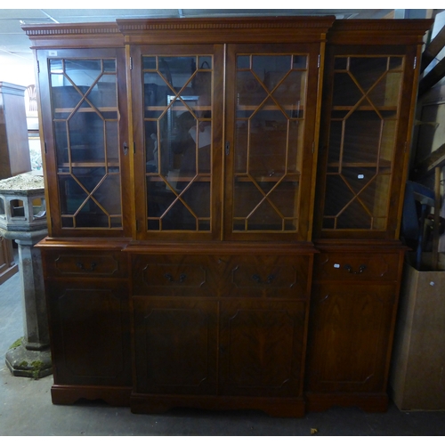 A REPRODUCTION YEW-WOOD BREAKFRONT LIBRARY BOOKCASE, HAVING FOUR ...