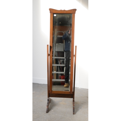 A FLOOR STANDING OAK FRAMED CHEVAL MIRROR