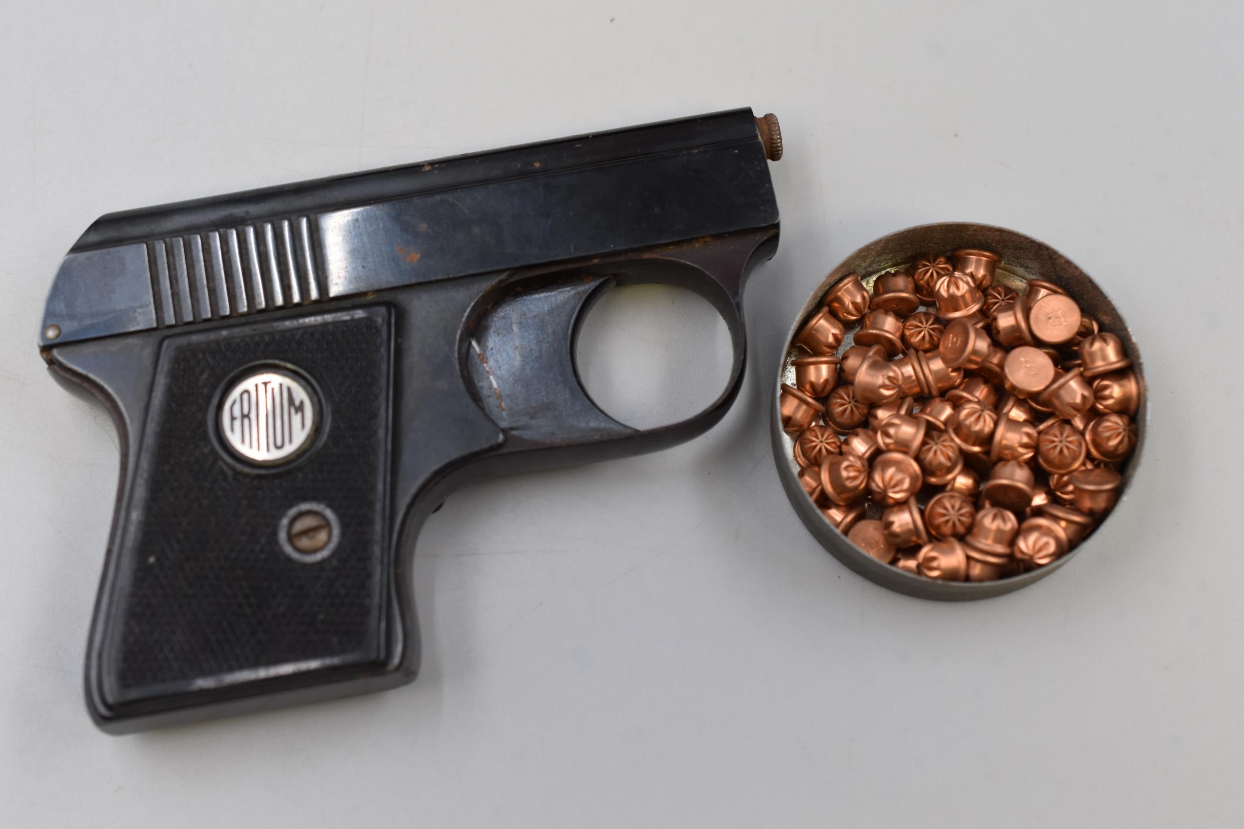 A boxed Fritum blank firing staring pistol with a tin of cartridges