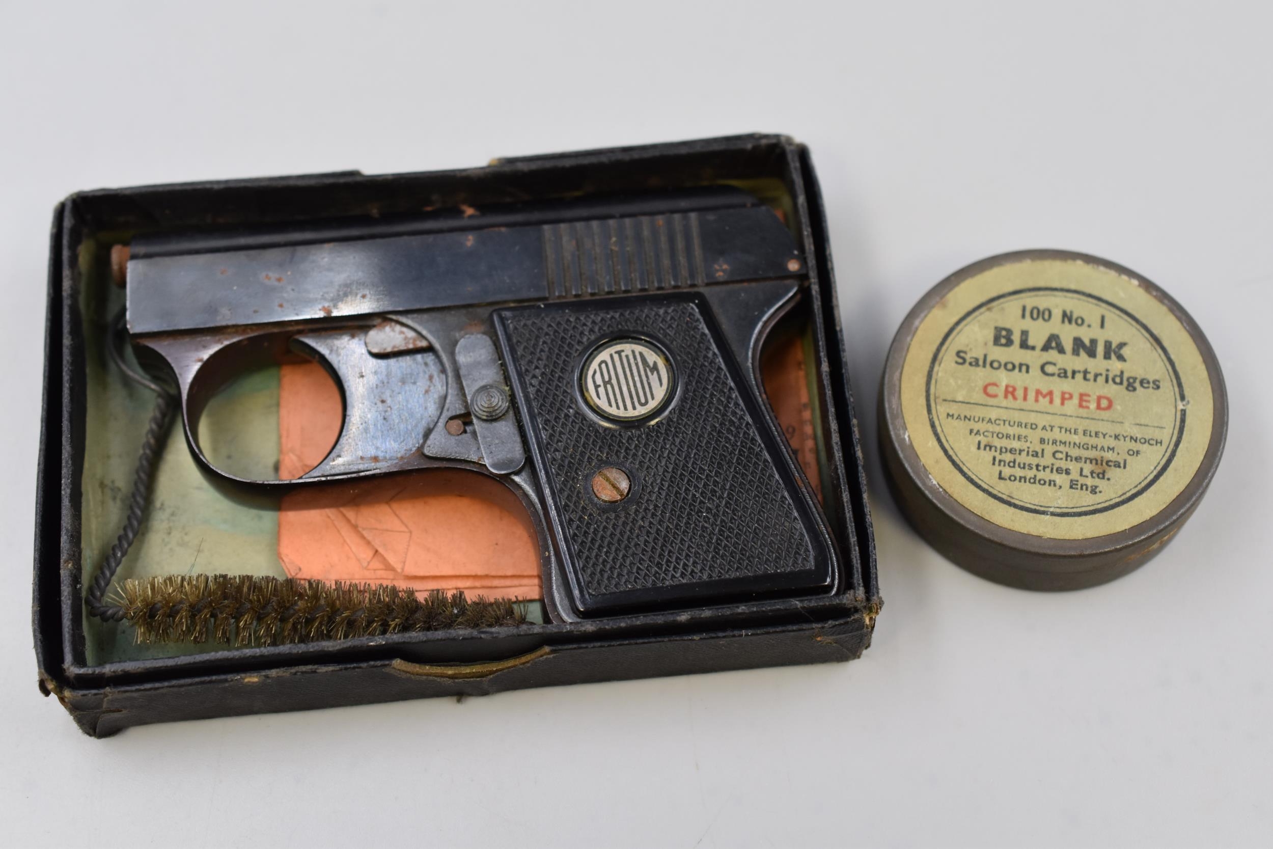 A boxed Fritum blank firing staring pistol with a tin of cartridges