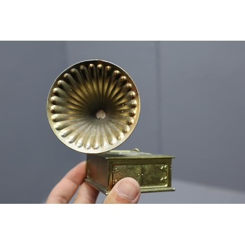 A large brass and steel cooking port with assorted brass items inside ...