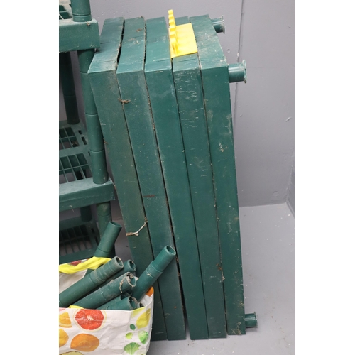 Nine sections of green plastic racking with connecting tubes/legs ...