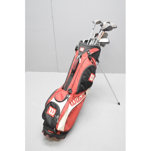 A Selection of Golf Clubs and Accessories in Wilson Golf Bag. To ...