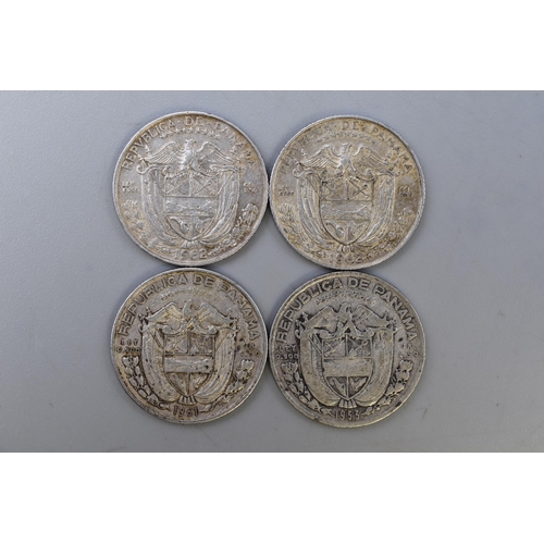 Four foreign silver coins.