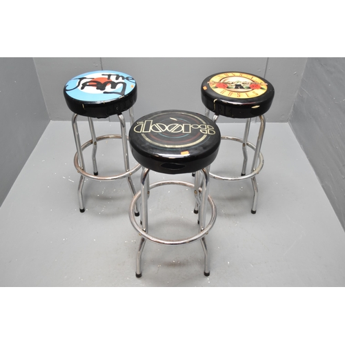 Three bar stools featuring band logos of Guns & Roses, The Doors and ...