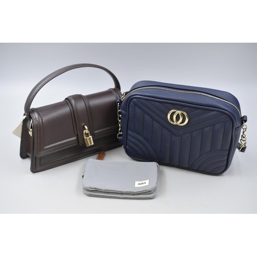 Two small primark bags one is brown and one is blue and a ROKA purse ...