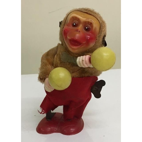 A vintage, clockwork monkey with maracas figure. Works intermittently.