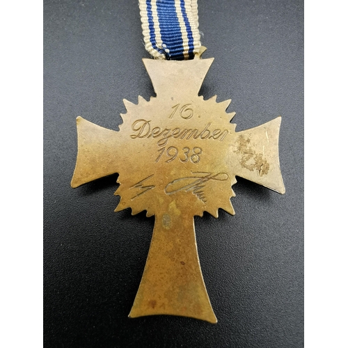 A WWII 'Cross of Honor of the German Mother' medal & ribbon. This award ...