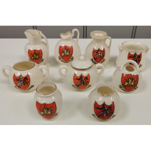 A twenty-six-piece collection of Warminster crested ware.
