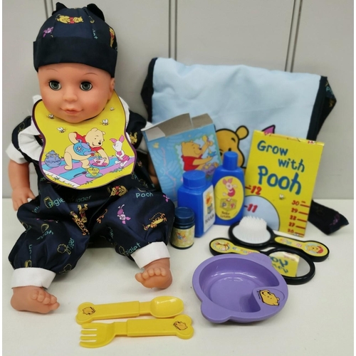 A Winnie The Pooh themed baby doll set. To include high chair bouncer toy box swing chair with