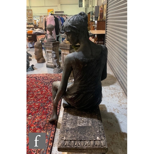 A life size cast metal figure of a female, cast in seated position and ...