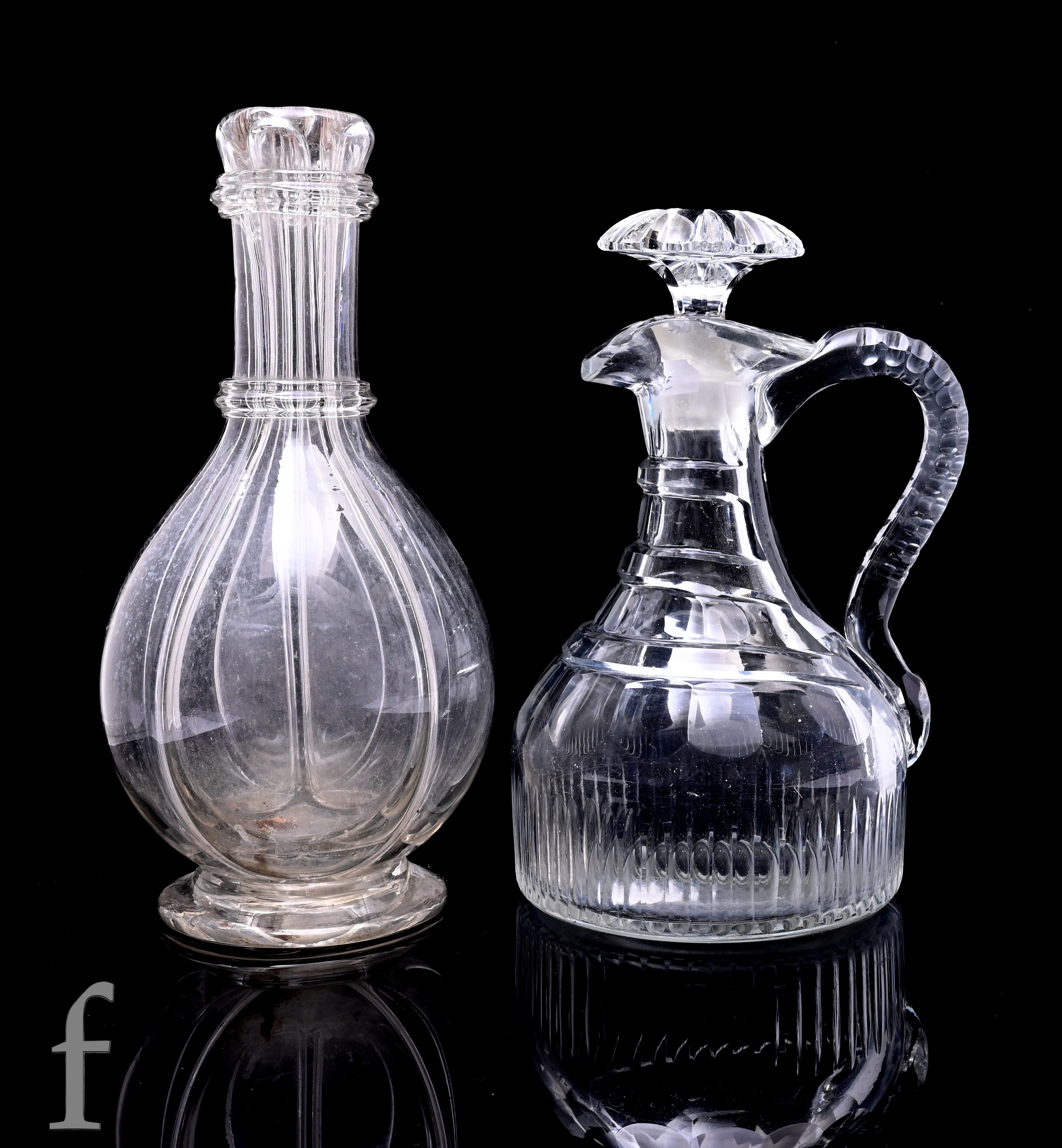 A later Georgian clear crystal claret jug, the compressed ovoid body ...