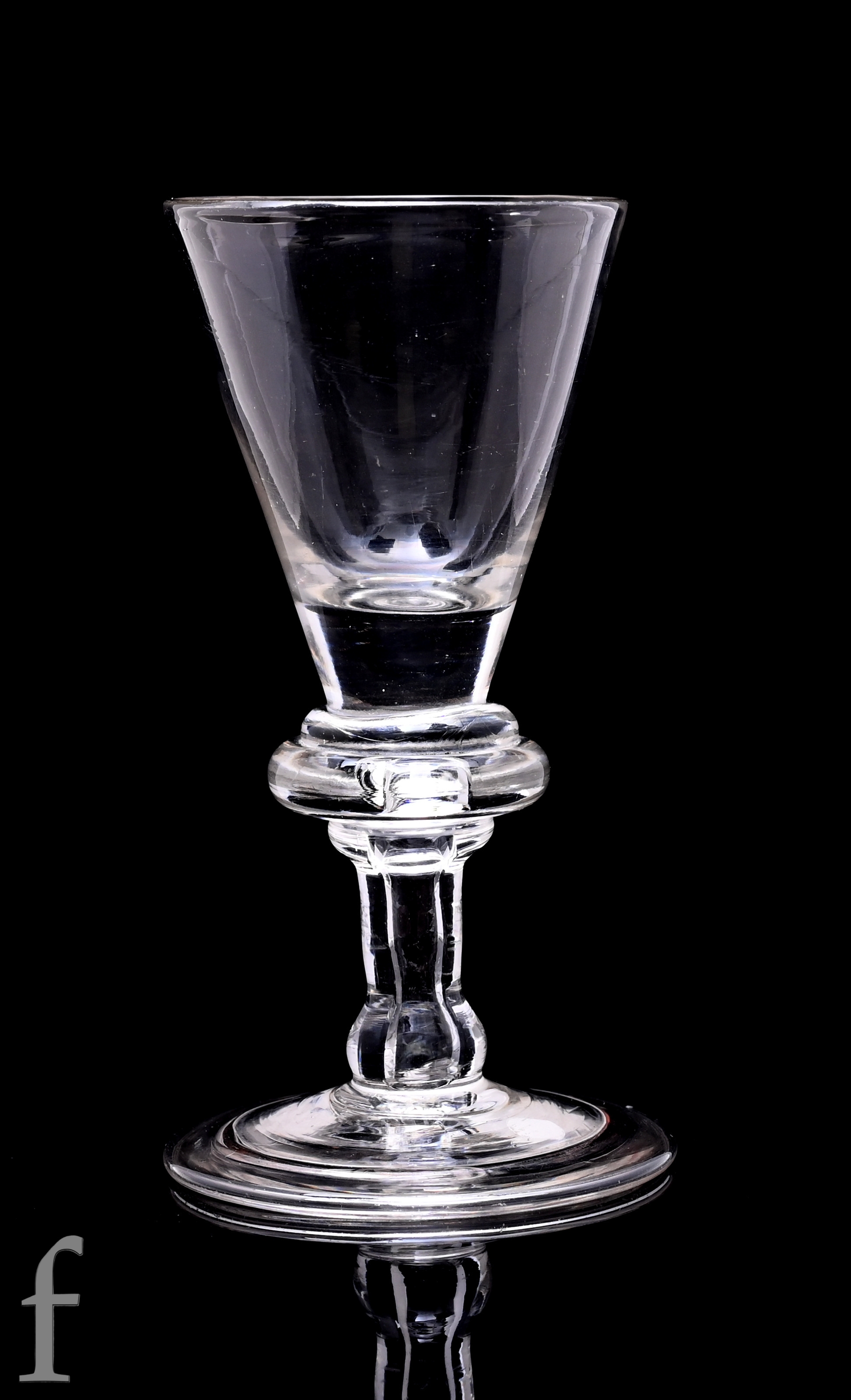 An 18th Century heavy baluster dram glass circa 1715, the conical bowl ...
