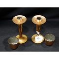 A Pair Of Engine Turned Copper Candle Sticks And Two Measures